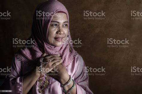 이슬람 히잡 머리 스카프와 이슬람 문화와 종교 개념에서 달콤하고 귀여운 미소 전통 옷을 입고 그녀의 50 대 행복하고 긍정적 인