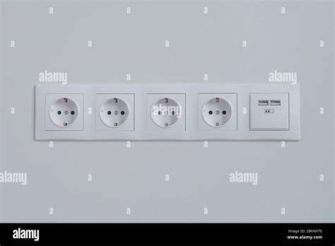 Group Of Empty Unplugged White Electrical European Outlet Socket With Usb Port Located On Gray