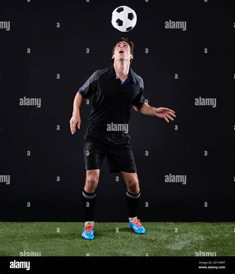 Hes Earning His Place A Handsome Soccer Player Isolated On Black Stock Photo Alamy