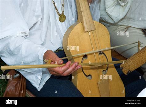 Closeup Of Musician Playing Medieval Fiddle In Period Costume At