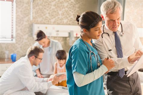 Male Doctor And Female Nurse Making Rounds Stock Image F0201675