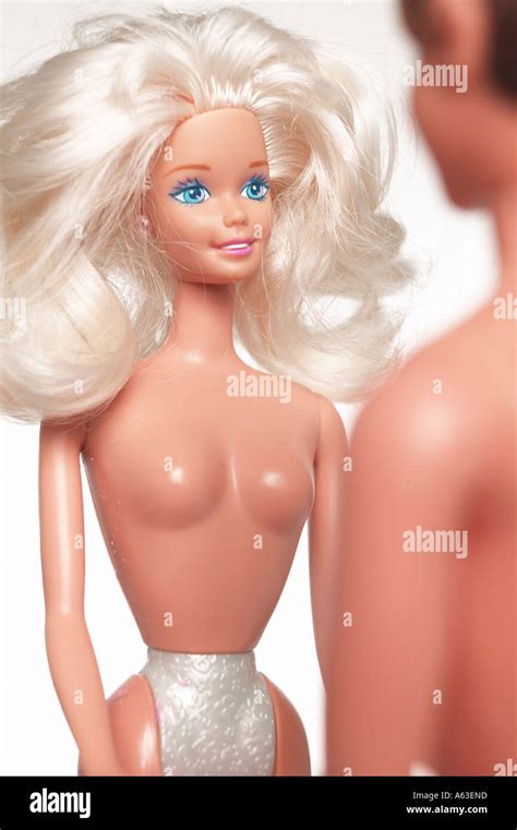 Naked Doll Standing In Front Of Toy Man Stock Photo Alamy