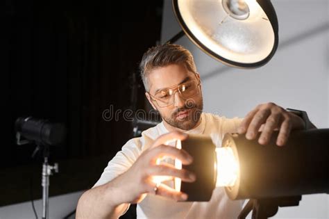 Creative Man Adjusting Lighting Equipment In Stock Image Image Of