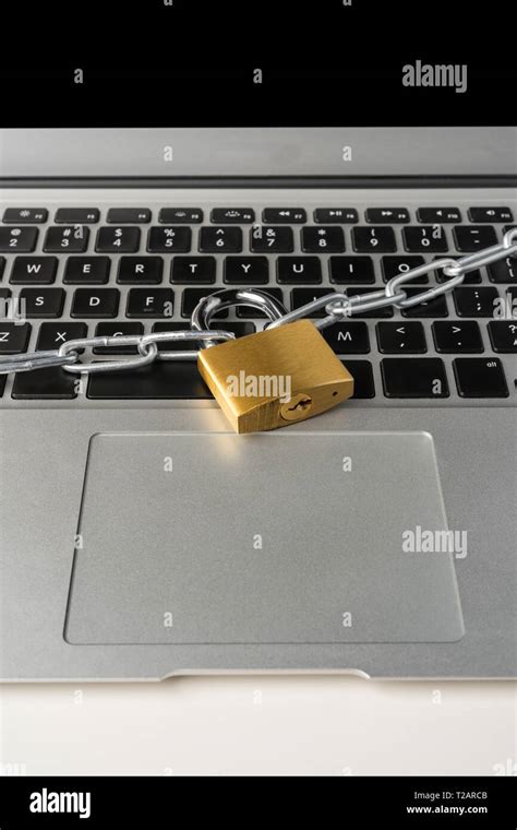 Padlock With Chain On A Laptop Computer Keyboard Cyber Security Abstract Concept Vertical