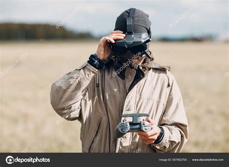 Man Controlling Fpv Quadcopter Drone With Goggles Antenna Remote