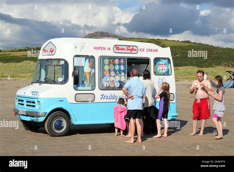 Ice Cream Van On A Beach In Wales People Queueing For Ice Creams On A
