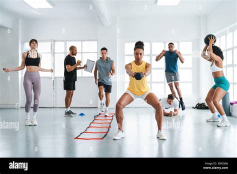 Multiethnic Group Of Sportive People Doing Functional Workout In Training Class Gym Group Of