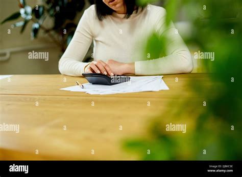 Woman Hand Using Calculator For Calculate Domestic Bills At Home Female Accountant Or Banker