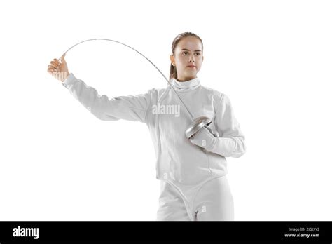 Young Girl Fencer In White Fencing Costume Posing With Rapier Isolated On White Background