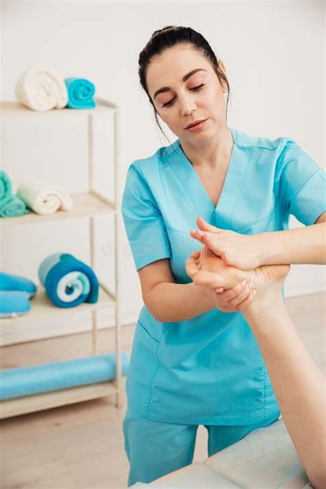 A Health Massage Therapist Does A Foot Massage For A Client In The