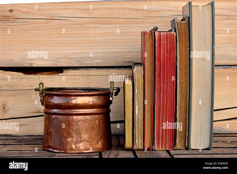 Copper Cauldron And Old Books Row Stock Photo Alamy