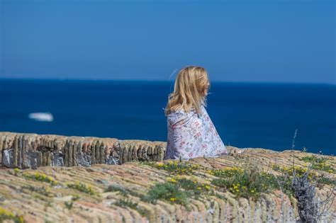 Premium Photo Woman Standing At Beach Against Sky