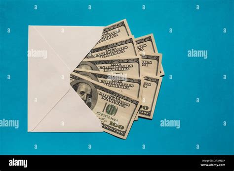 Dollar Banknote Saving Money In Envelope On Blue Background Copy Space