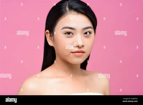 Beautiful Asian Woman With Smooth Skin And Long Black Hair On Pink