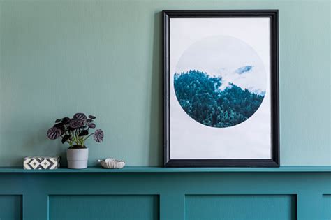 포스터 프레임 식물 및 선반에 우아한 액세서리를 갖춘 우아한 아파트의 세련된 거실 인테리어 녹색 나무 패널입니다 현대 홈 스테이징 템플릿 홈 장식 0명에 대한 스톡 사진 및