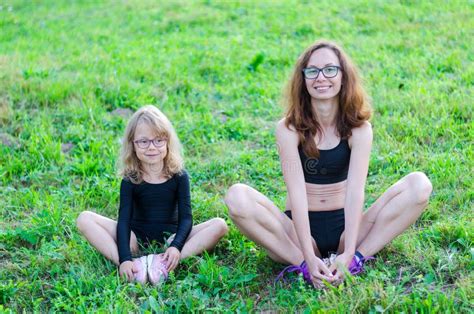 Mom And Daughter Are Sitting In A Lotus Position In Nature Stock Image