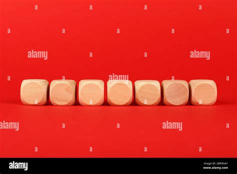 Close Up Seven Blank Empty Wooden Cube Signs Over Red Background With