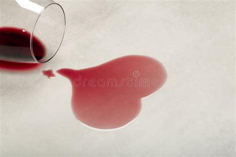 Wooden Floor With Overturned Glass Of Red Wine Spilled Wine On A