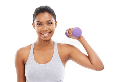 In Good Shape And Feeling Great A Young Woman Exercising With Weights