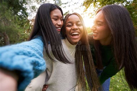 Portrait Of Three Girls Outside Having Fun Taking Selfie Friendship In