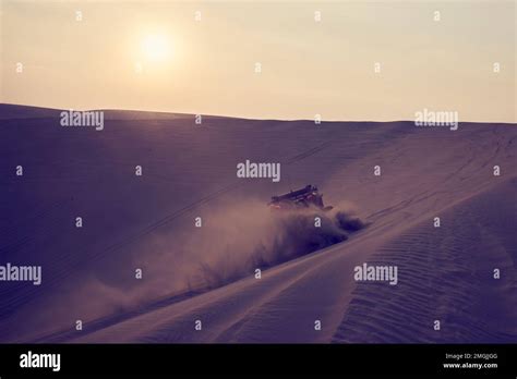 A 4x4 Buggy Racing Over The Dunes Near Doha Where Tourists And Qataris