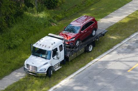 First Responders Helping On Car Accident Site Tow Truck Loading