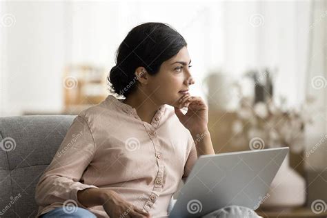 Serious Pensive Young Indian Freelancer Woman Working At Home Stock