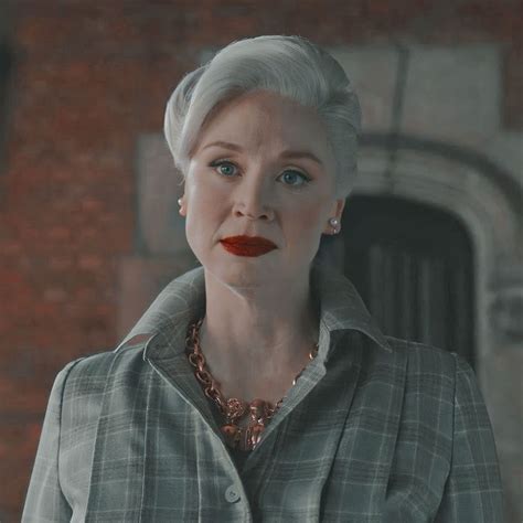 An Older Woman With White Hair And Red Lipstick