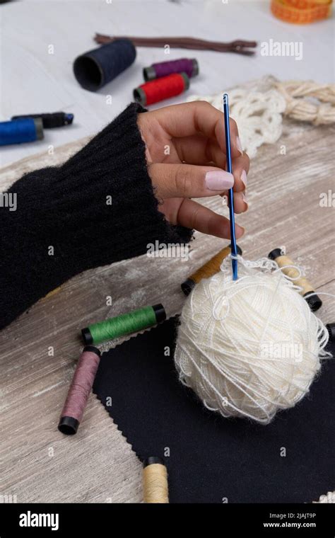 Workplace With White Roll Of Wool With Crochet Surrounded With Colored