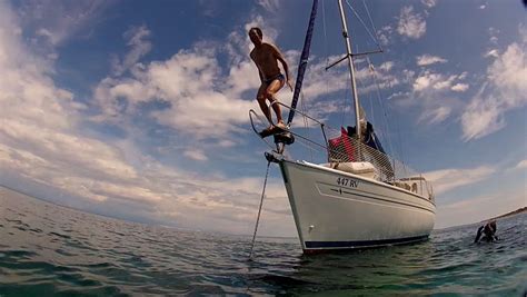 Man Jumping Into Sea From Boat In Mediterranean Stock Footage Video
