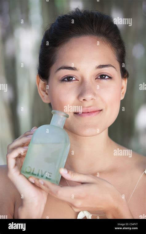 Portrait Of A Beautiful Young Woman Holding Bottle Of Olive Oil Stock