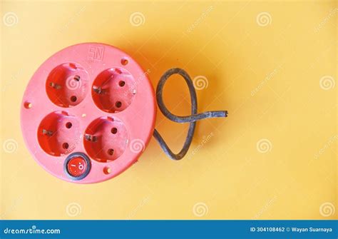 Used Broken Electric Extension In Red Color With Black Cable On The