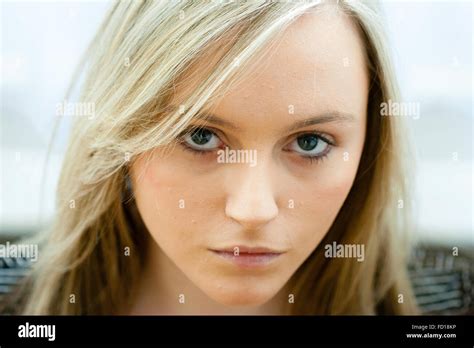Blonde Teenage Girl Close Up Of Face Bent Slightly Forward But Blue