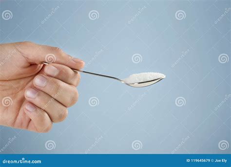 Hand Holding Spoon Filled With Sugar Stock Image Image Of Blue Sweet