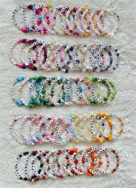 Six Bracelets With Different Colors And Designs On Them Sitting Next To