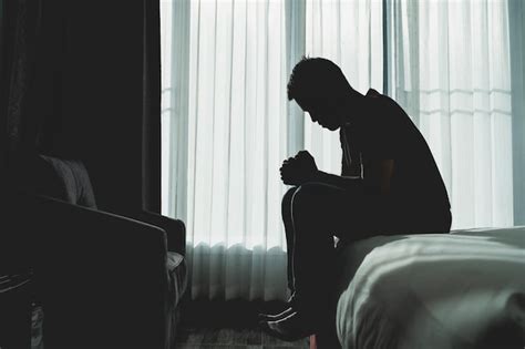 Premium Photo Silhouette Depressed Man Sadly Sitting On The Bed In