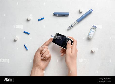 Diabetic Woman With Digital Glucometer And Insulin On White Background
