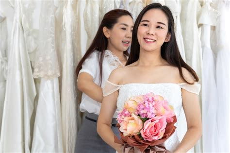 Premium Photo Portrait Of Asian Woman Choosing Dress In A Shop With