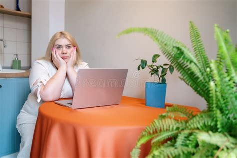 Tired Overworked Plus Size Woman Sitting In Stress Or Depression At