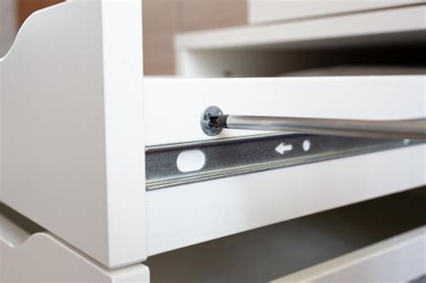 Premium Photo Furniture Assembly Process Master Assembles The Bedside Table The Worker Uses A