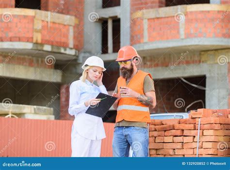 Discussing Plan Woman Engineer And Builder Communicate At Construction Site Stock Photo Image