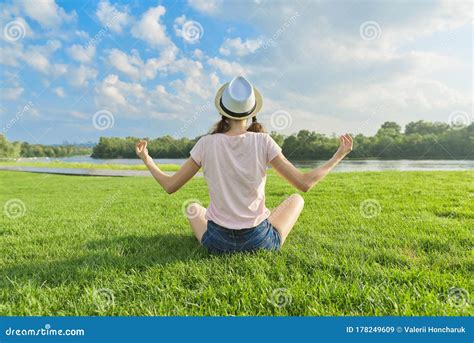 Girl Sitting In Lotus Position On The Green Grass Back View Beautiful