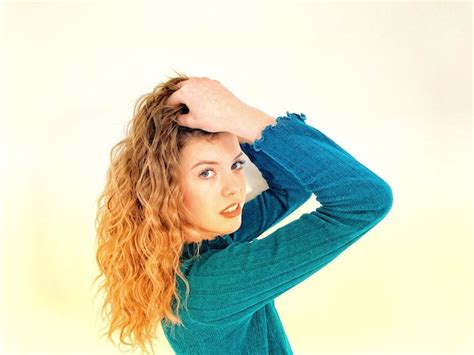 Premium Photo Portrait Of Smiling Young Woman Standing Against White