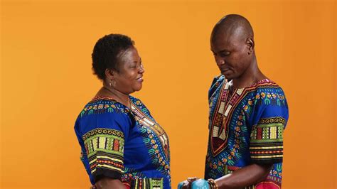 Joyful Woman Helping Her Husband To Lift Heavy Dumbbells Trying To