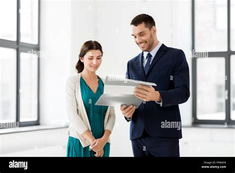 Realtor With Folder Showing Documents To Customer Stock Photo Alamy