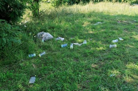 Premium Photo Plastic Bottles On The Grass Garbage Pollution