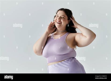 An Elegant Plus Size Woman Playfully Poses Showcasing Her Confidence