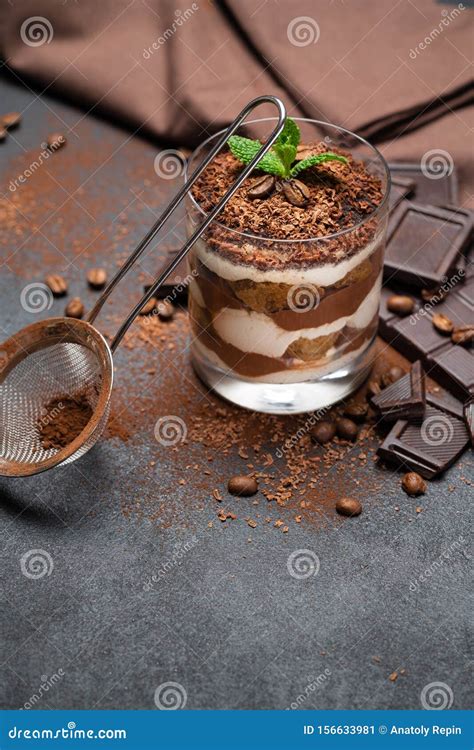 Classic Tiramisu Dessert In A Glass Cup Strainer And Pieces Of