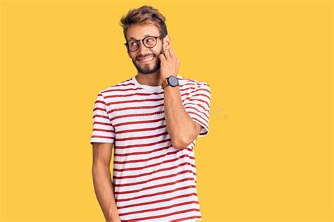 Handsome Blond Man With Beard Wearing Casual Clothes And Glasses