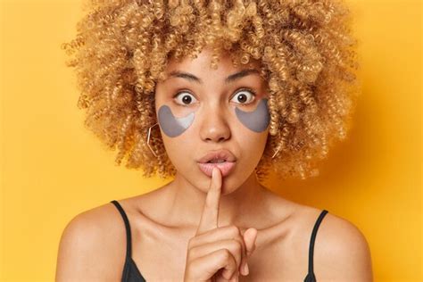 Premium Photo Photo Of Mysterious Curly Haired Young Woman Makes